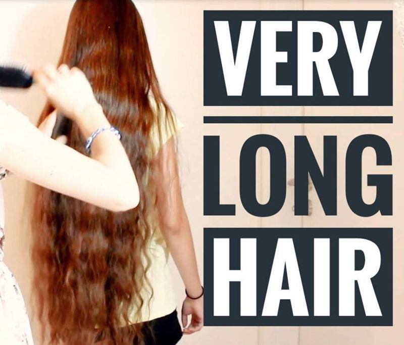 Real life Rapunzel in red sits with loose hair (Series