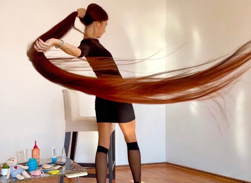 Real life Rapunzel in red wrapped in hair several time